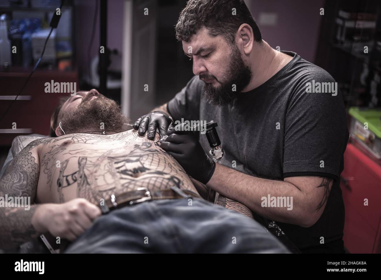 Professional tattoo artist makes tattoo pictures in studio Stock Photo ...
