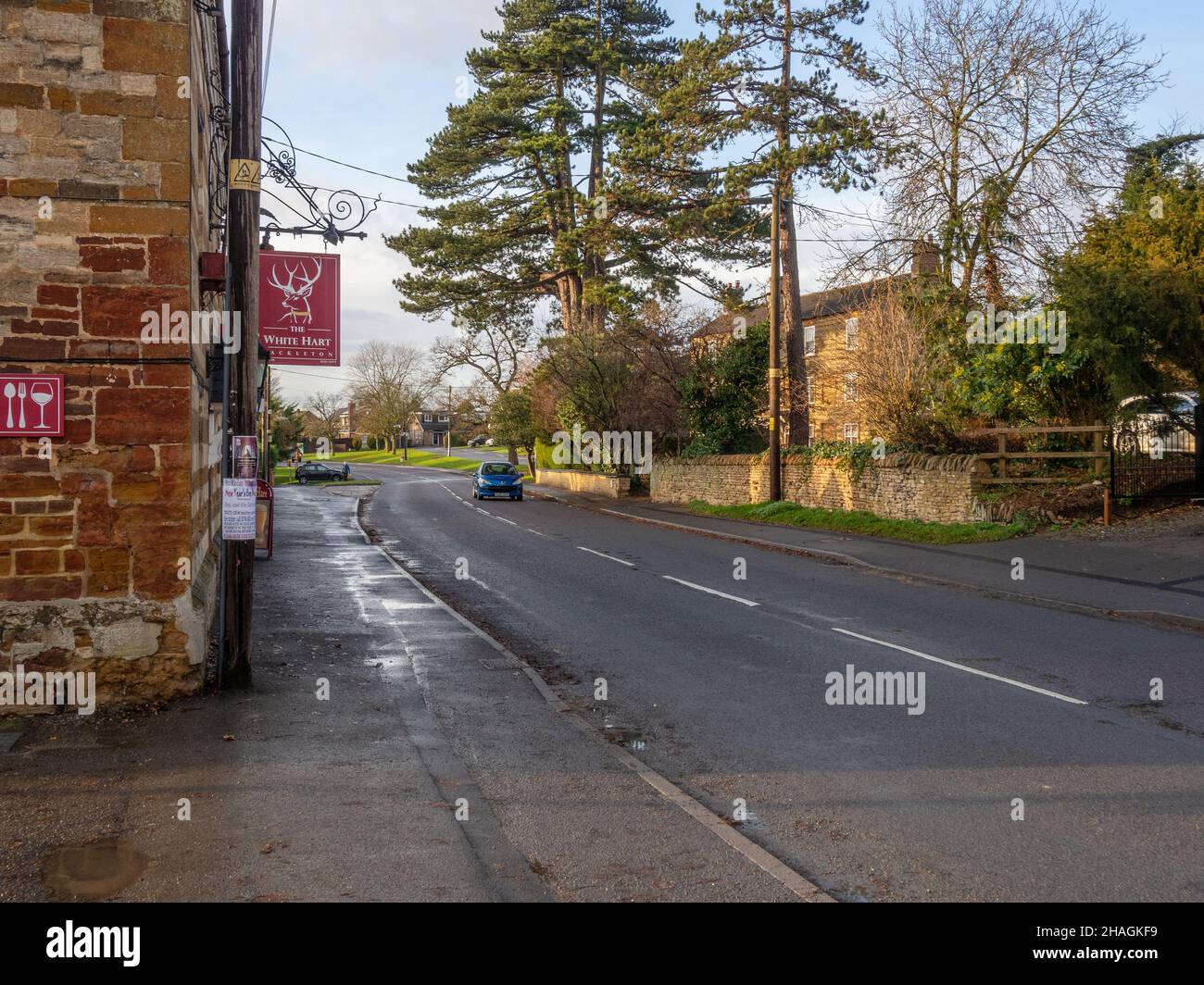 Street scene in winter, Hackleton village, Northamptonshire, UK; White ...