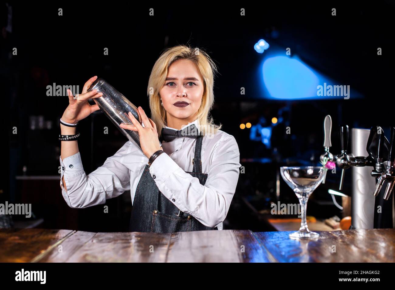 Girl bartender creates a cocktail on the saloon Stock Photo - Alamy