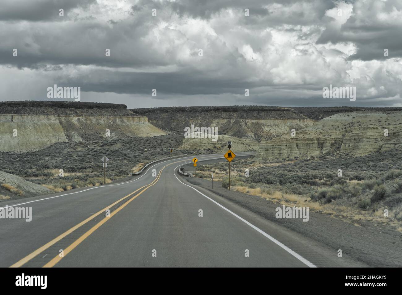 U.S. 95 asphalt highway in Eastern Oregon under a gray sky with large ...