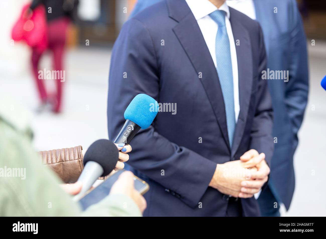 Press conference, journalists with microphones interviewing politician ...
