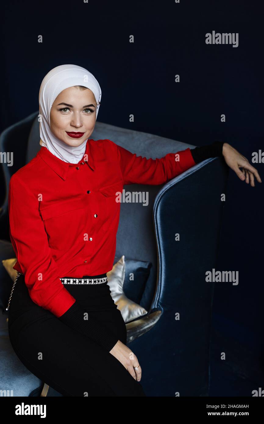 Muslim woman near christmas decoration in studio. Professional muslim ...