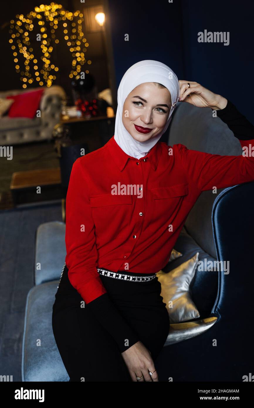 Muslim woman near christmas decoration in studio. Professional muslim ...