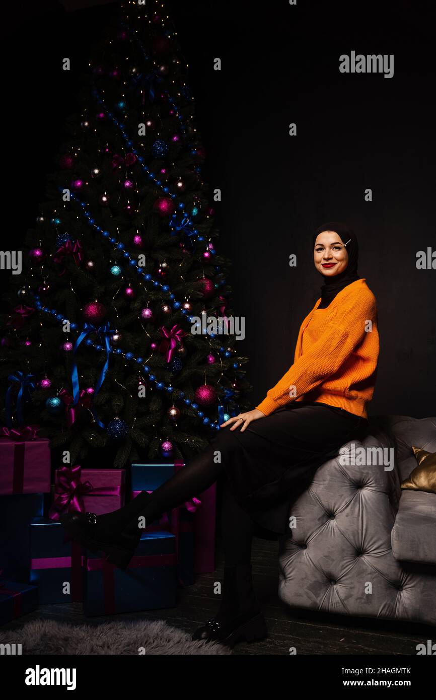 Muslim woman in black hijab near new year tree waiting for celebration ...