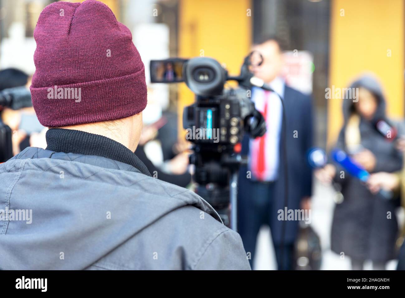 News or press conference. Filming media event with a television camera ...