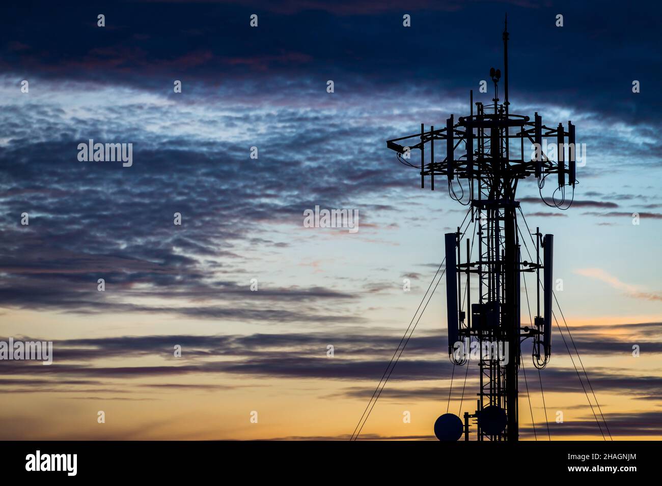 Silhouette communication tower poles on sunset background Stock Photo ...