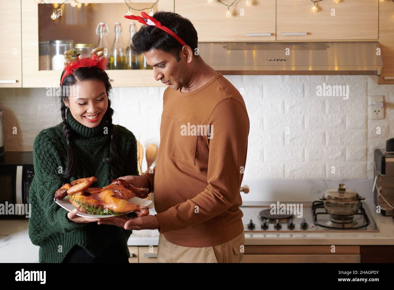 Excited young man looking at fried chicken his wife cooked for ...