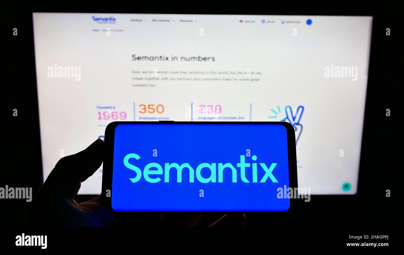 Person holding mobile phone with logo of Swedish language company ...