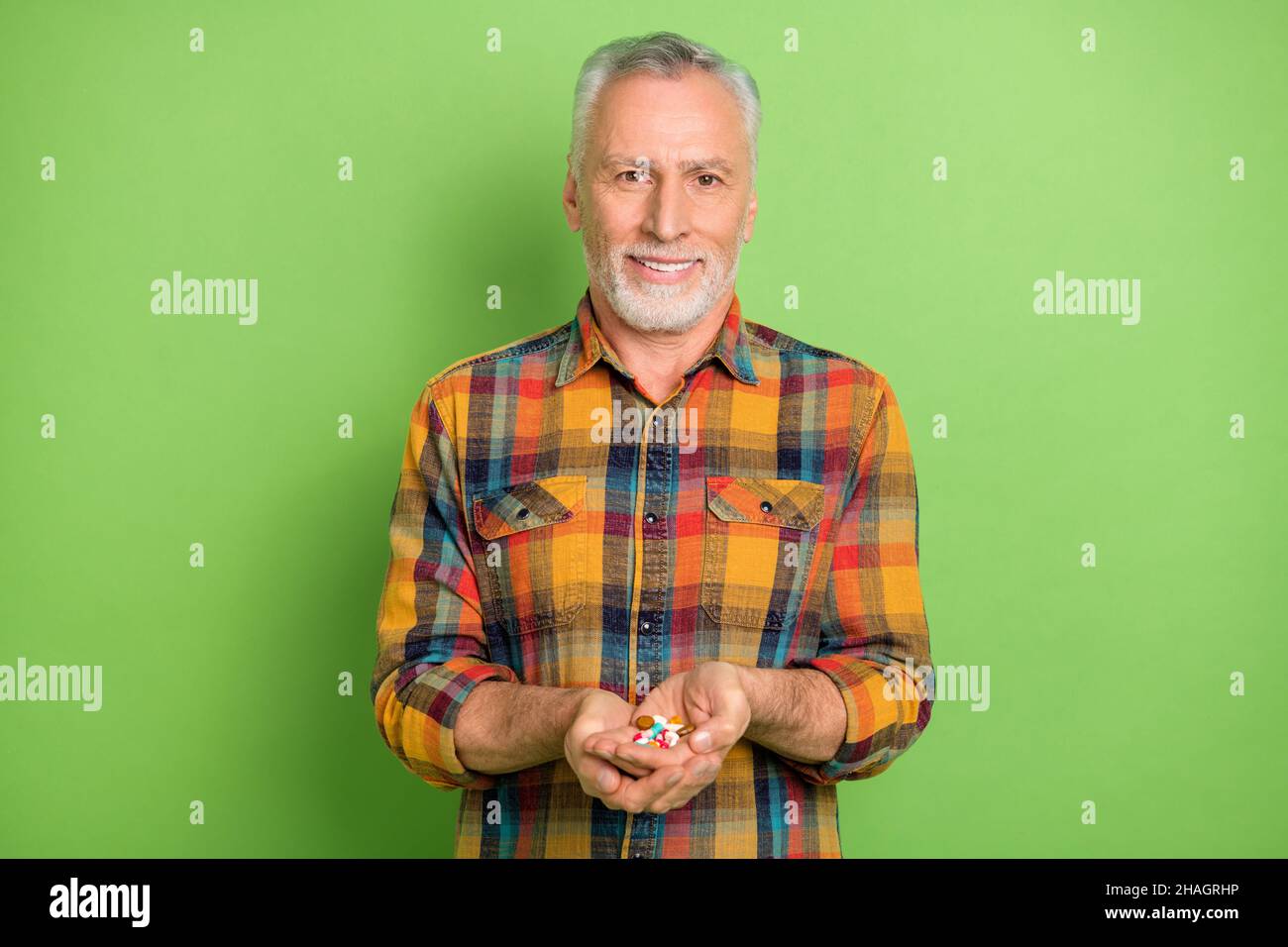 Photo of nice elder beard man hold pills wear yellow shirt isolated on ...
