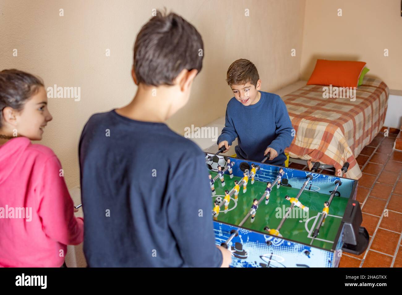 KIds playing table soccer at home Stock Photo - Alamy