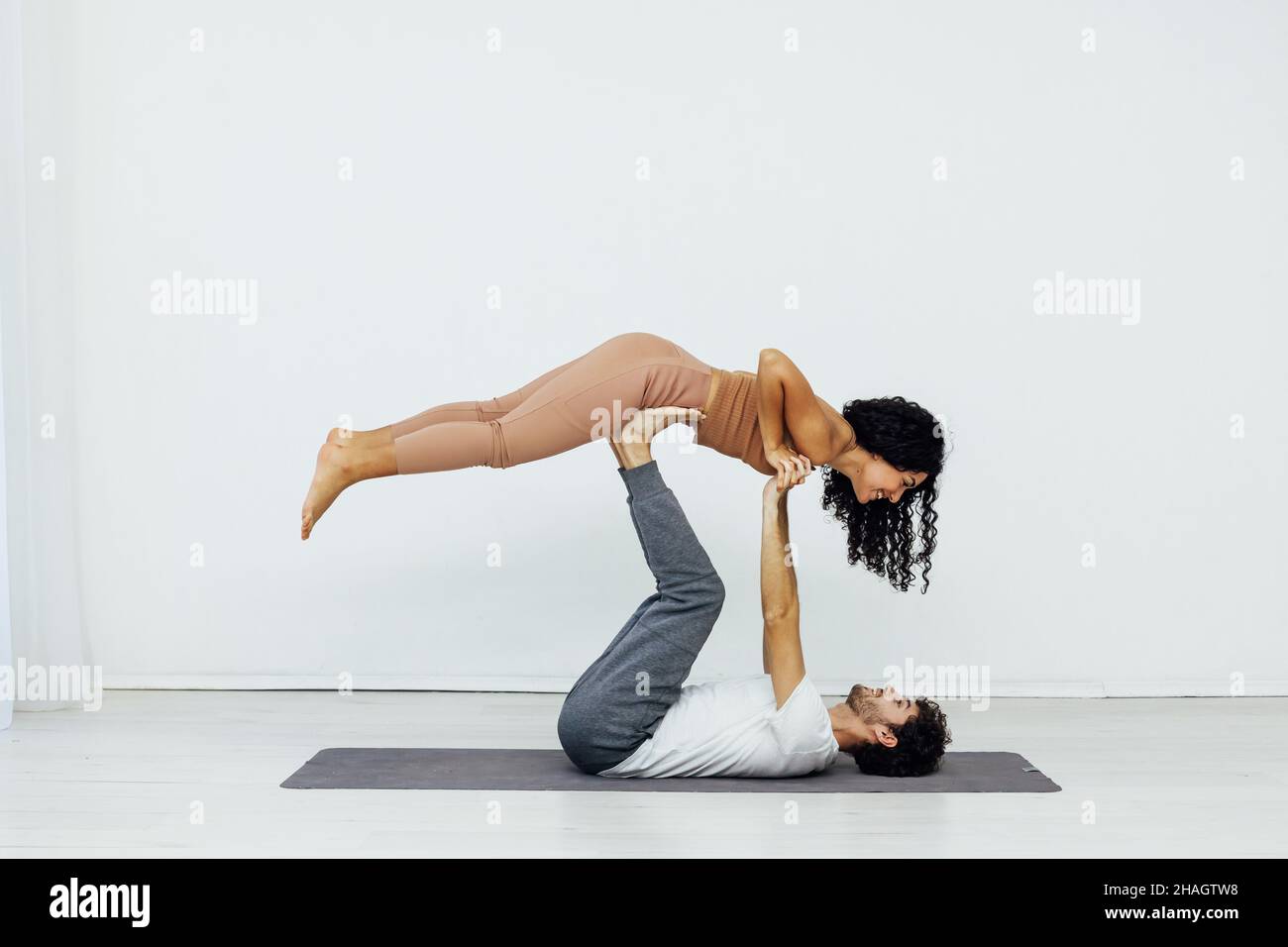 man and woman together doing exercises yoga asana fitness Stock Photo ...