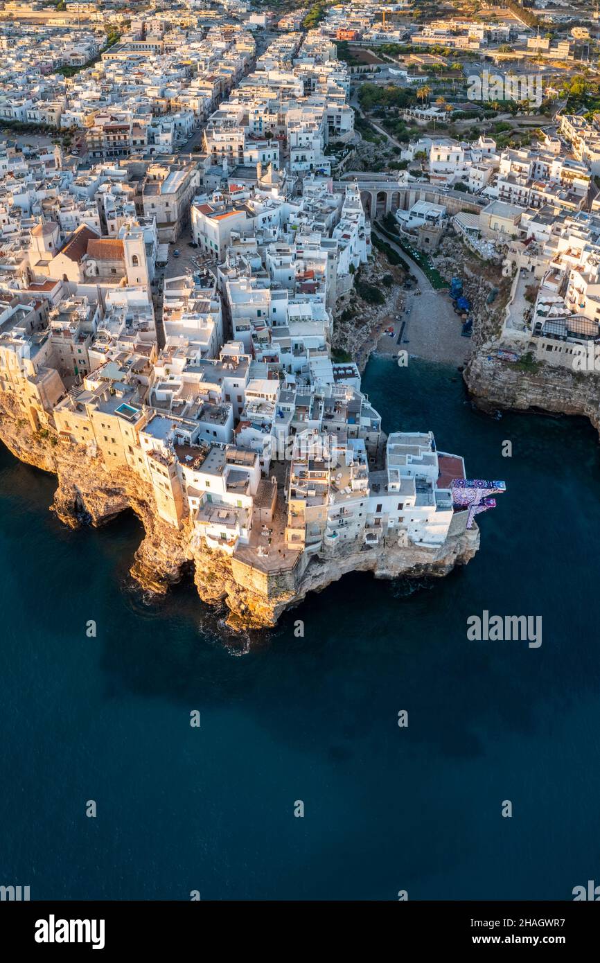 Aerial view of the overhanging houses of Polignano a Mare at sunrise ...
