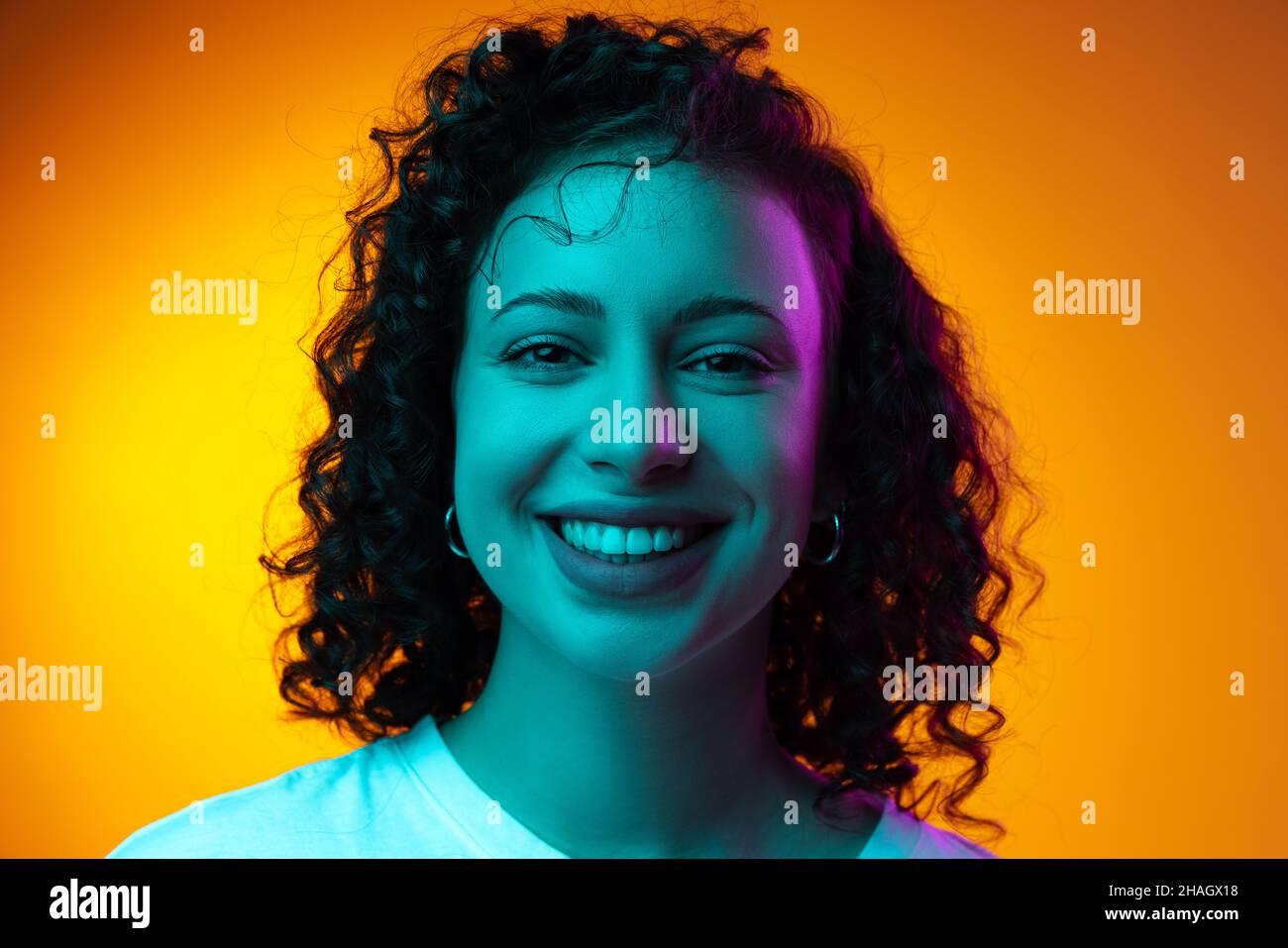Close-up young beautiful cheerful girl smiling isolated on yellow brown ...