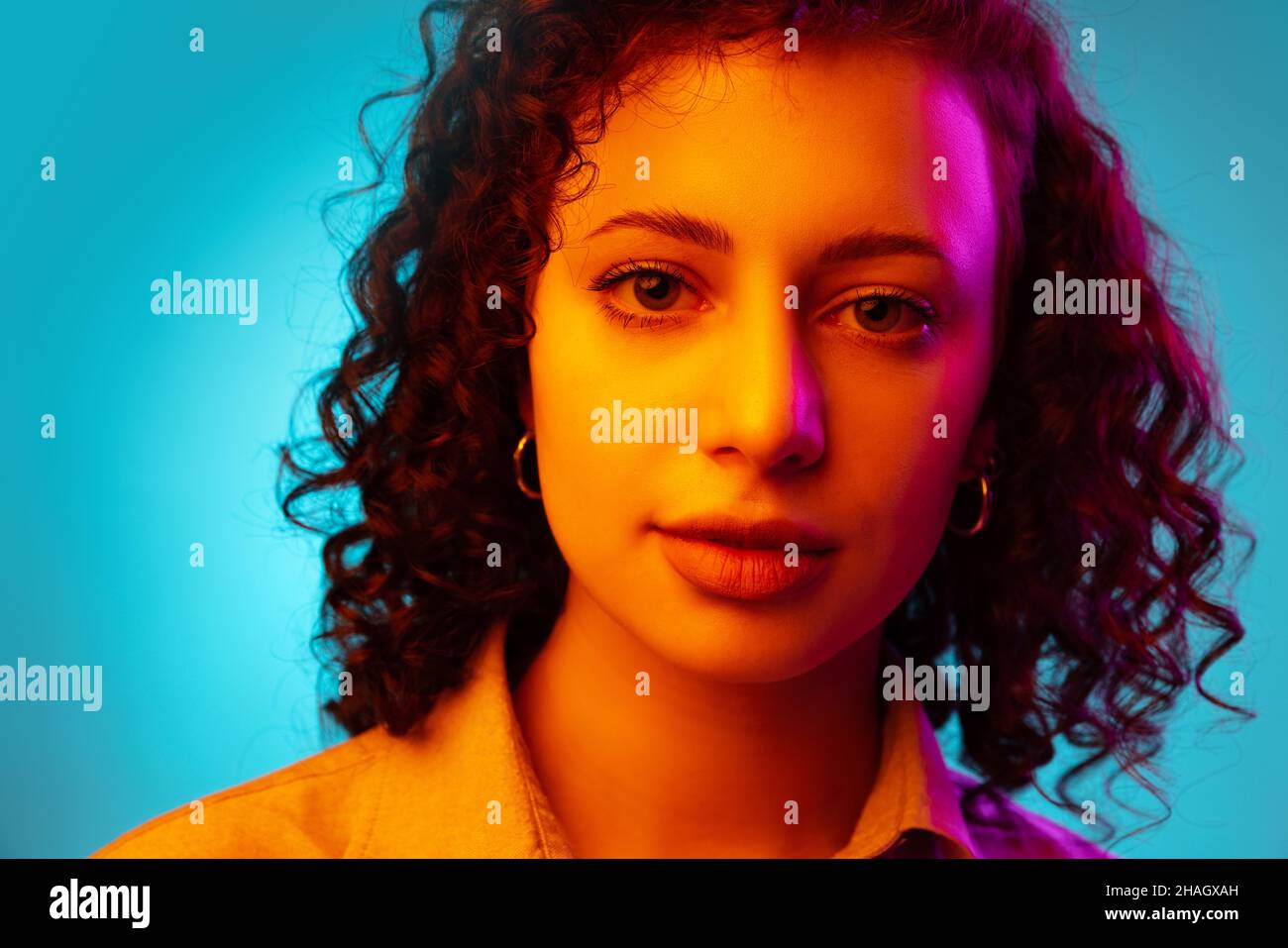 Close-up young beautiful serious girl looking at camera isolated on ...