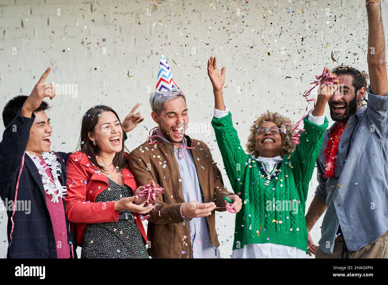 Happy Friends celebrating with confetti together having fun Stock Photo ...