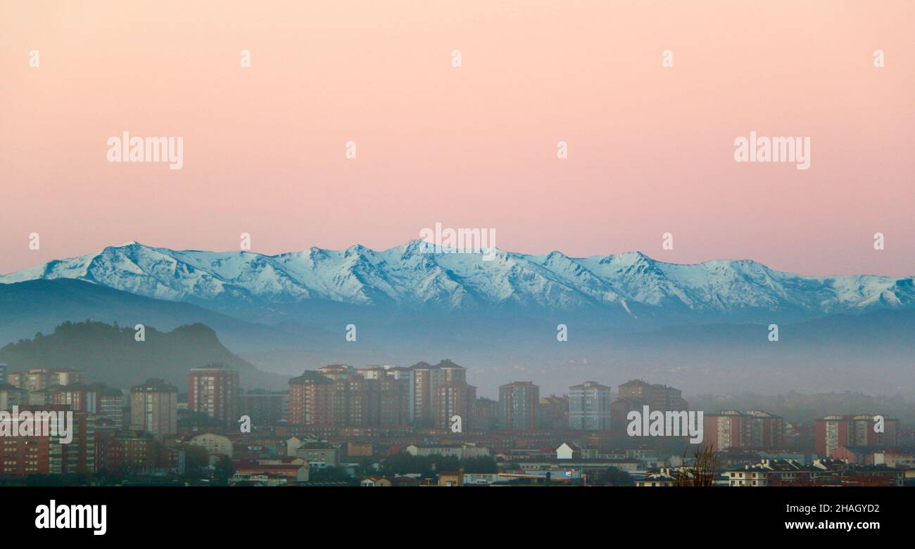 Dawn view of snow capped Picos de Europa mountain range with low lying ...