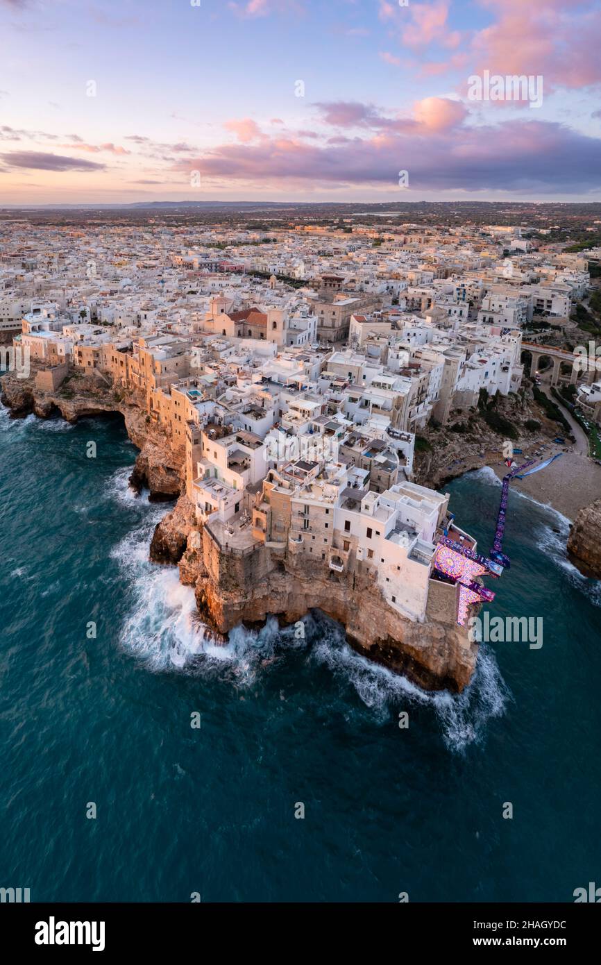 Aerial view of the overhanging houses of Polignano a Mare at sunrise ...