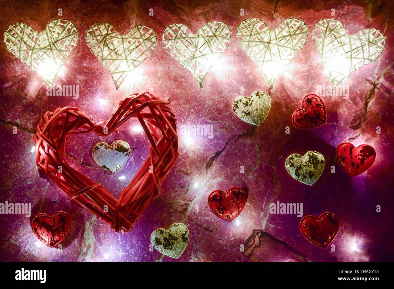 Five handmade wicker decorative hearts with light bulbs hang on the ...