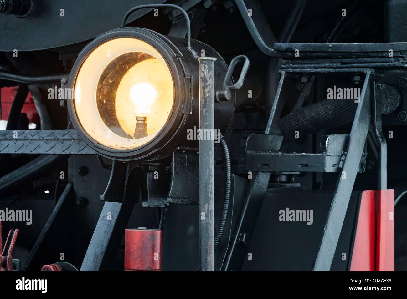 Detail of yellow glowing headlight of old black steam locomotive Stock ...