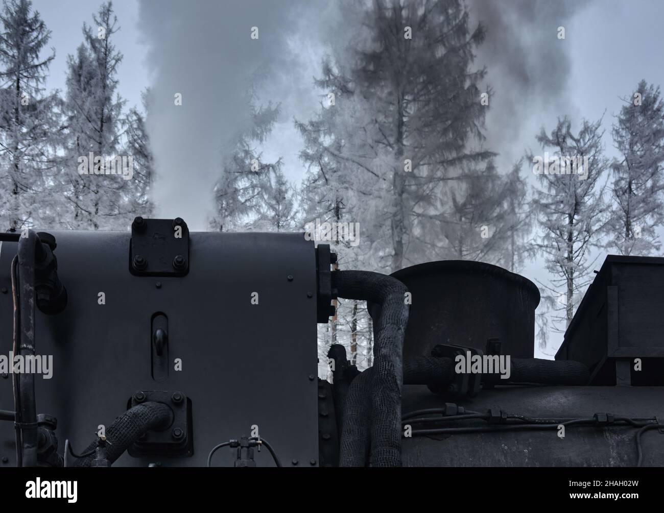 Close-up of the upper part of a steam locomotive emitting white hot ...