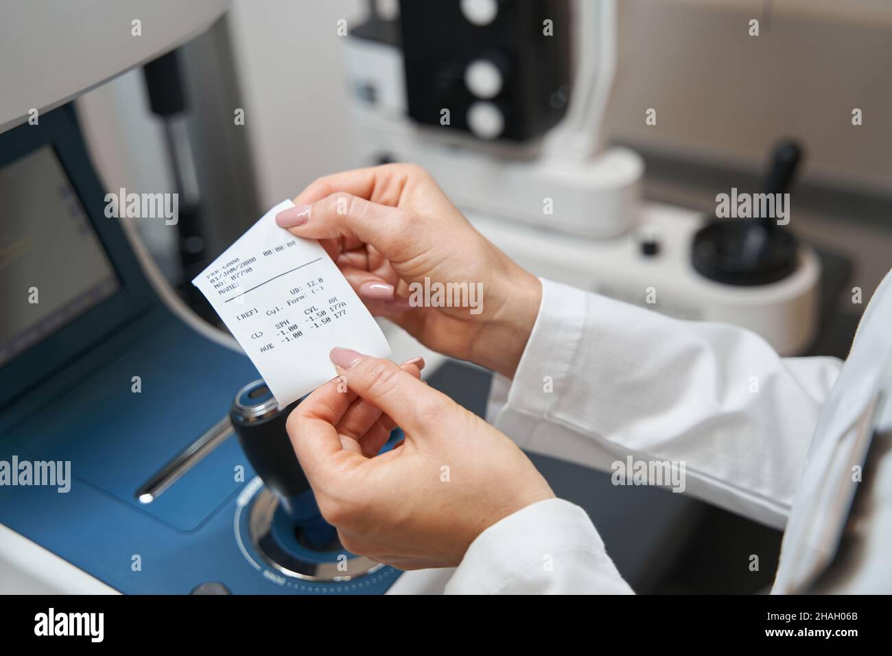 Eye doctor looking at autorefractor examination results Stock Photo - Alamy