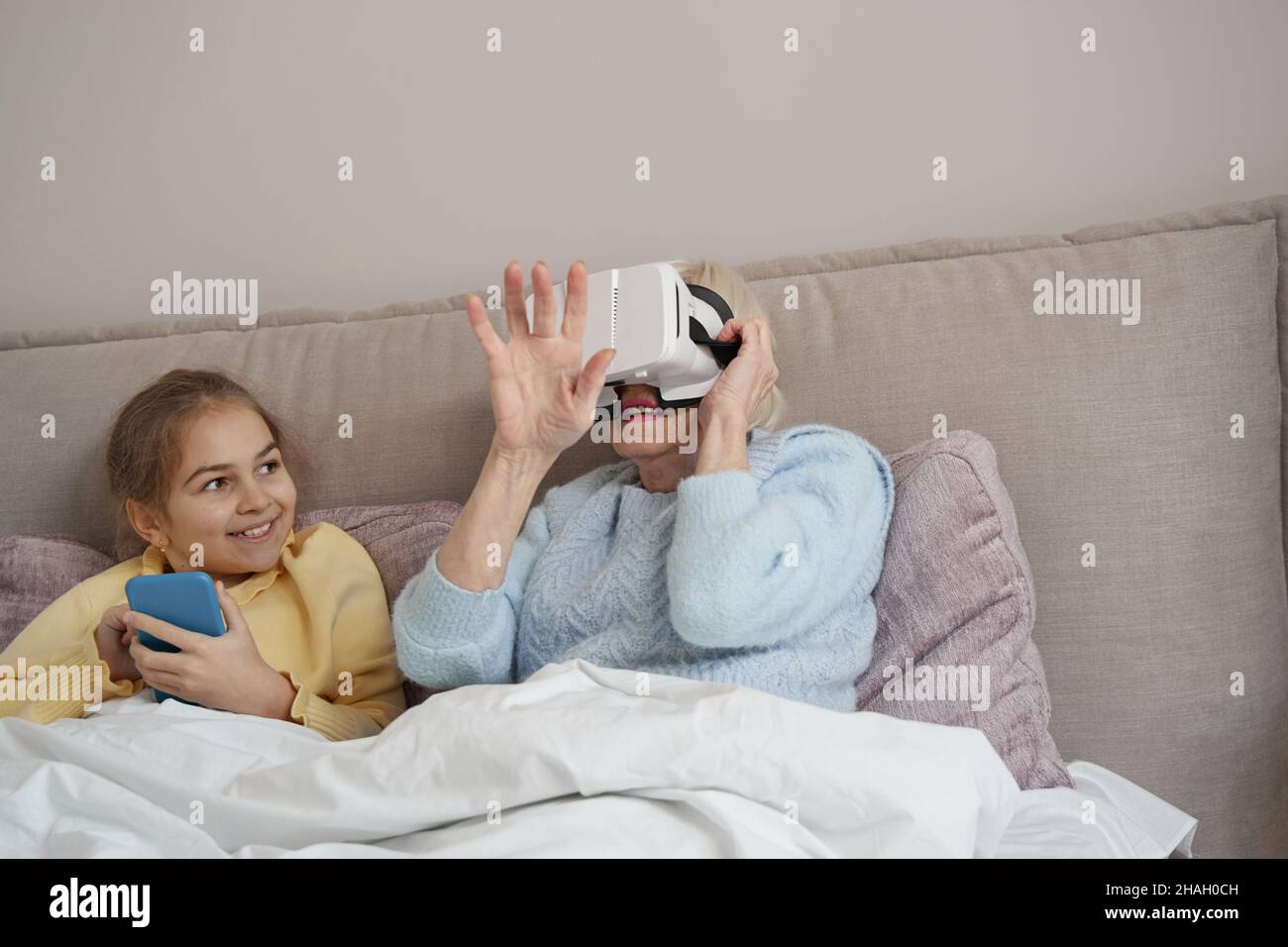 Cheerful granddaughter being supportive of her grandma exploring ...