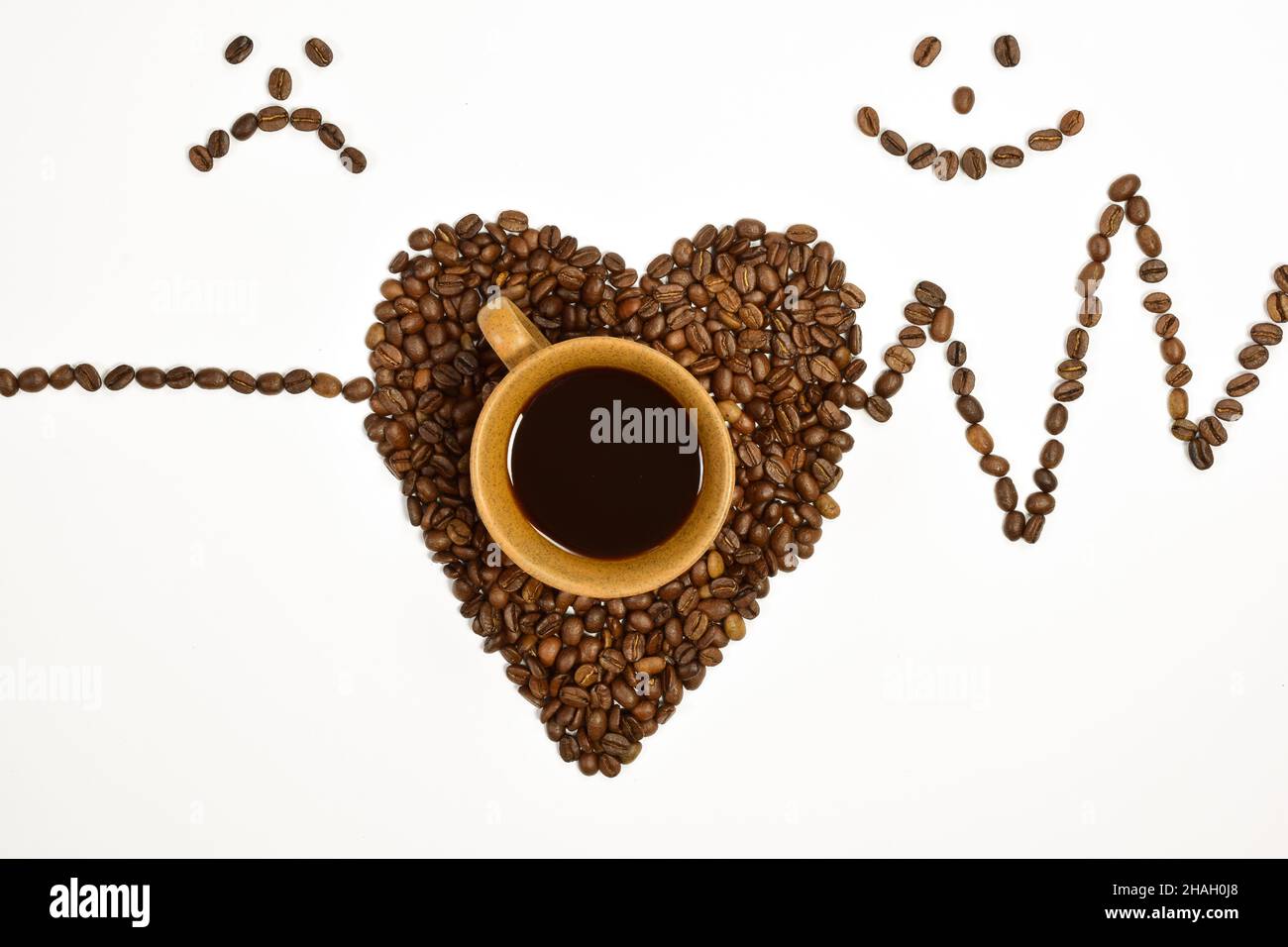 On a white background, there is a cup of coffee, a heart shape is laid ...