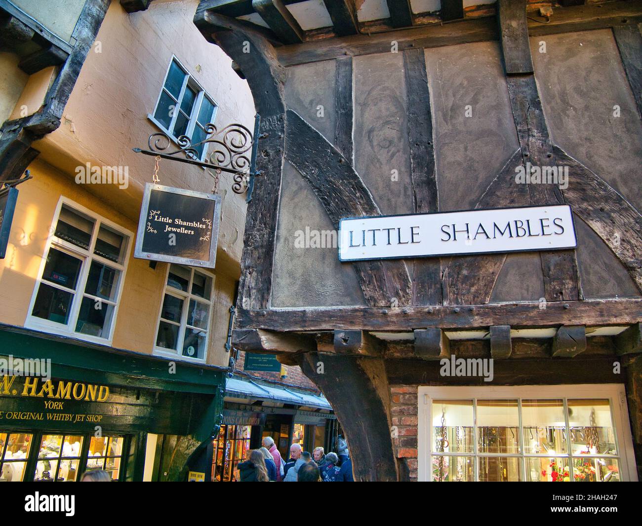 On the side of an old, timbered building, the road sign of the old ...