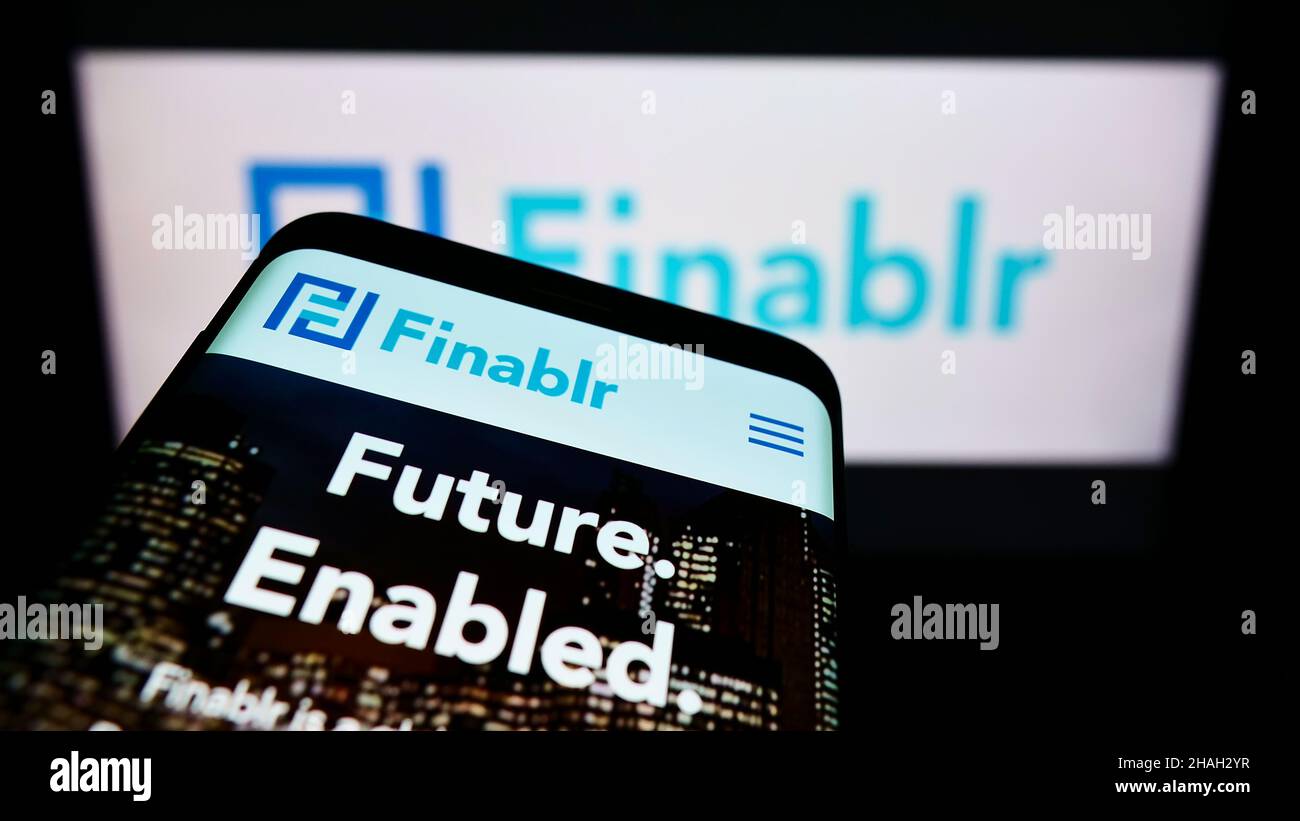 Smartphone with website of payment platform company Finablr plc on ...