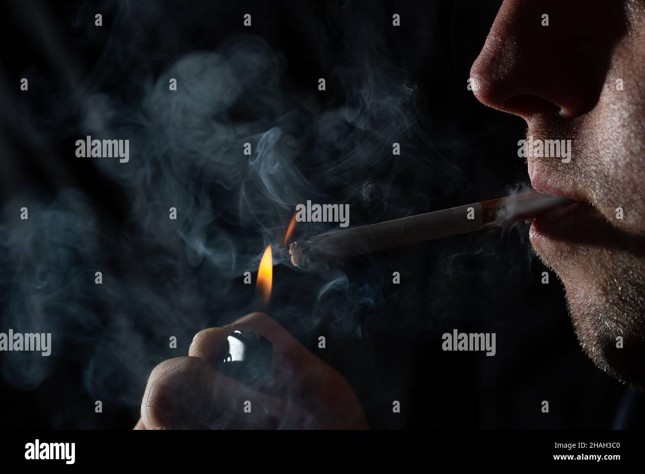 portrait of a smoking young man. Handsome young man thoughtfully and ...