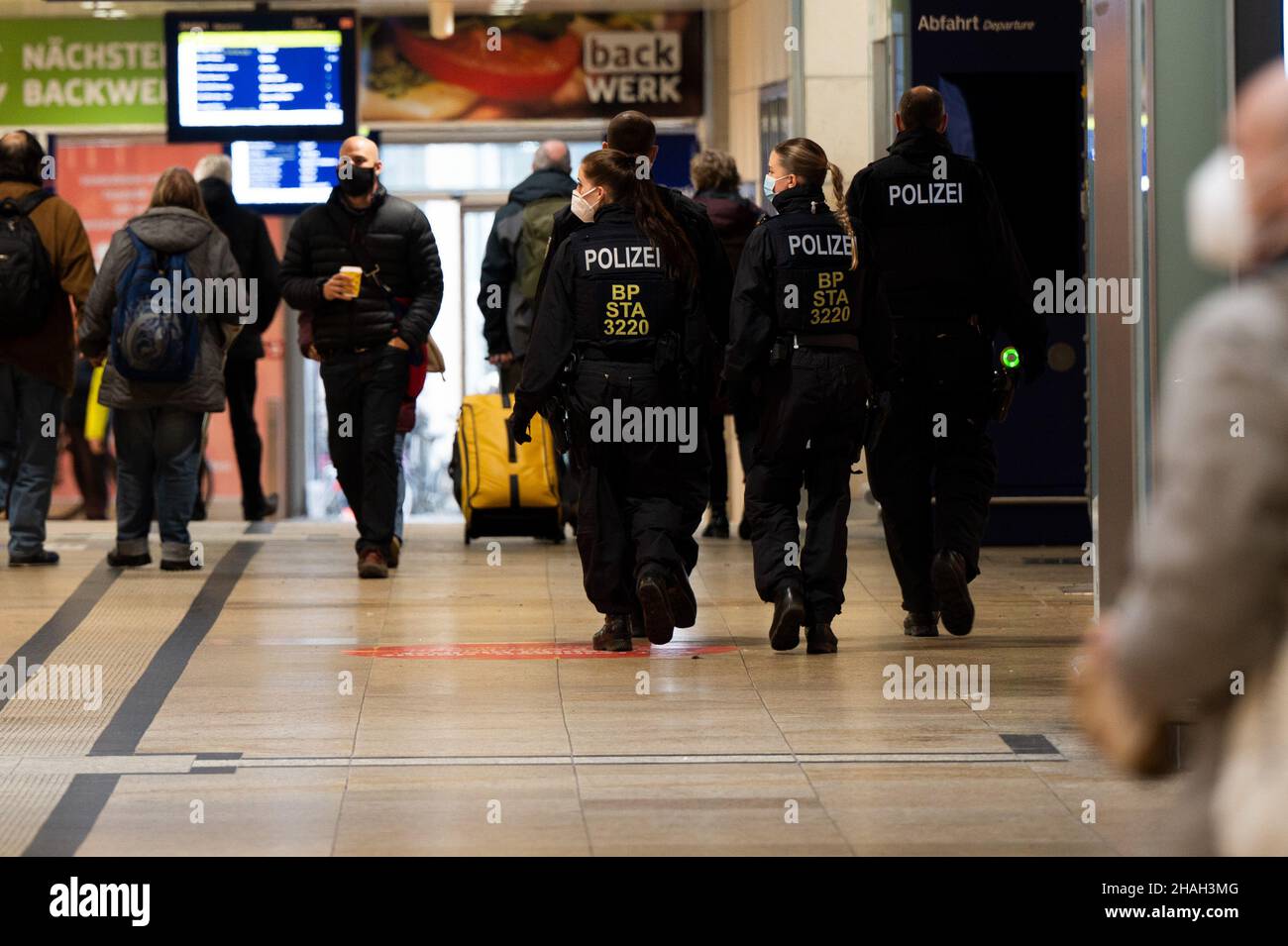 Cologne, Germany. 13th Dec, 2021. Police officers walk in a group ...