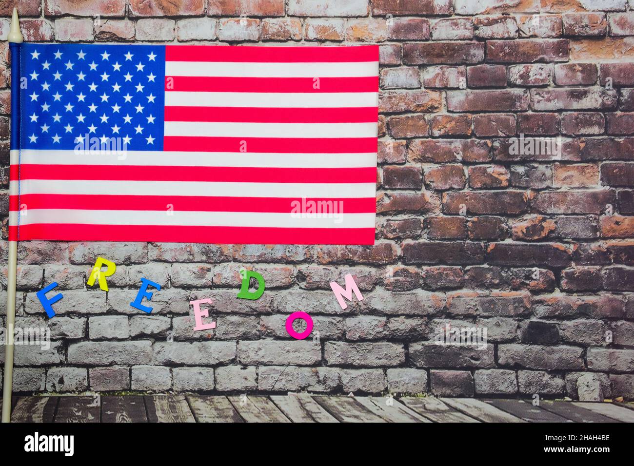 The word FREEDOM is lined with multicolored letters under the US flag ...
