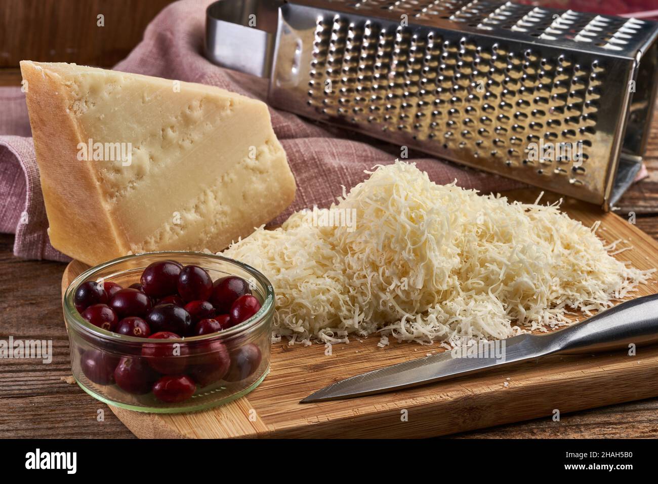 Portion of parmesan grated from a large block of parmigiano reggiano ...