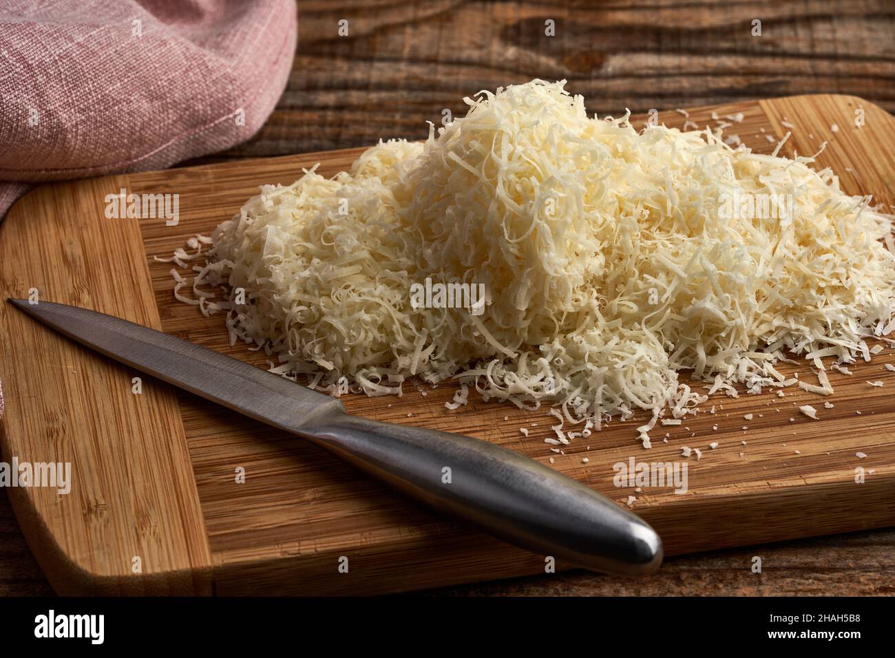 Portion of parmesan grated from a large block of parmigiano reggiano ...