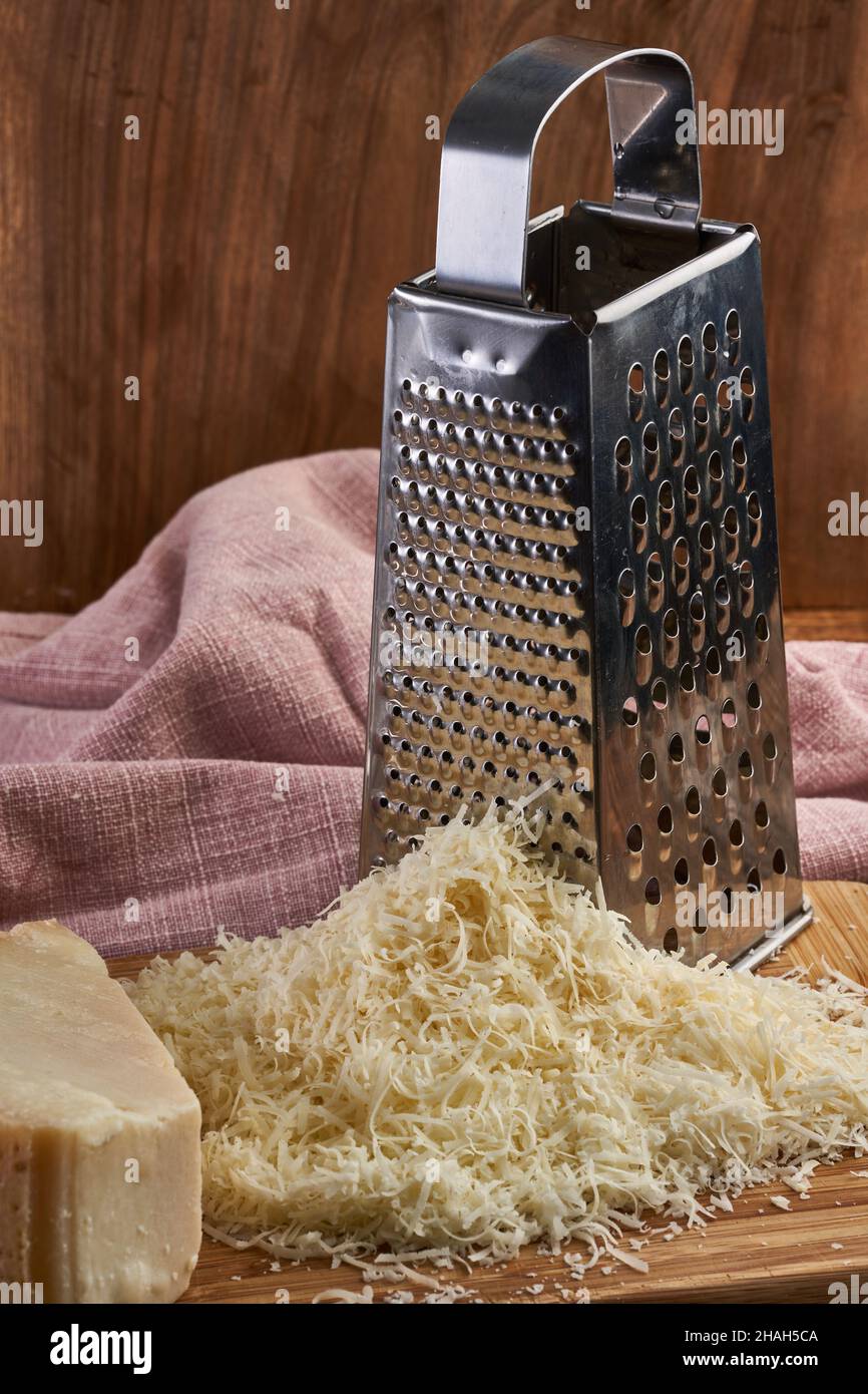 Portion of parmesan grated from a large block of parmigiano reggiano ...