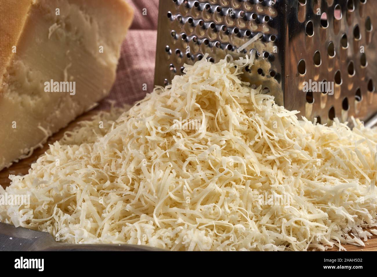 Portion of parmesan grated from a large block of parmigiano reggiano ...