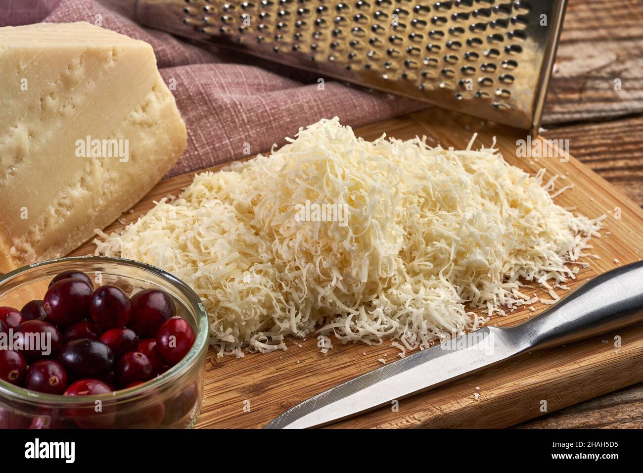 Portion of parmesan grated from a large block of parmigiano reggiano ...