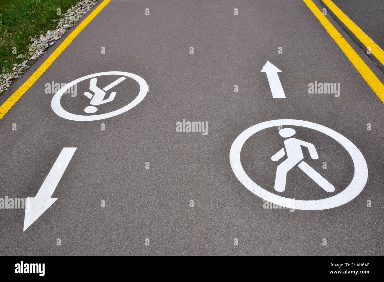 On the asphalt road there are signs for pedestrians in both directions ...