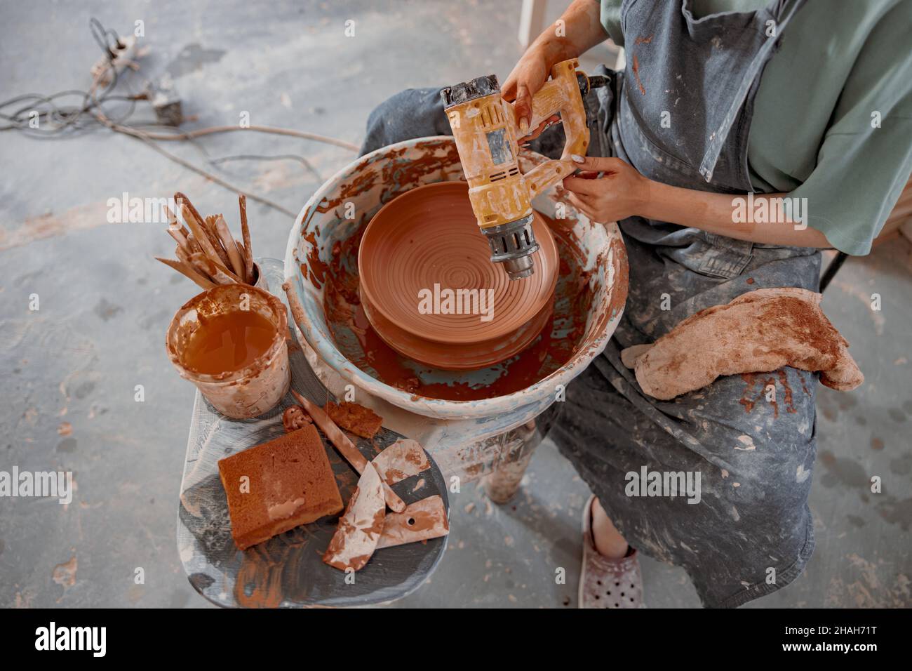 Handmade artist creating earthen bowl on circle in art studio Stock ...