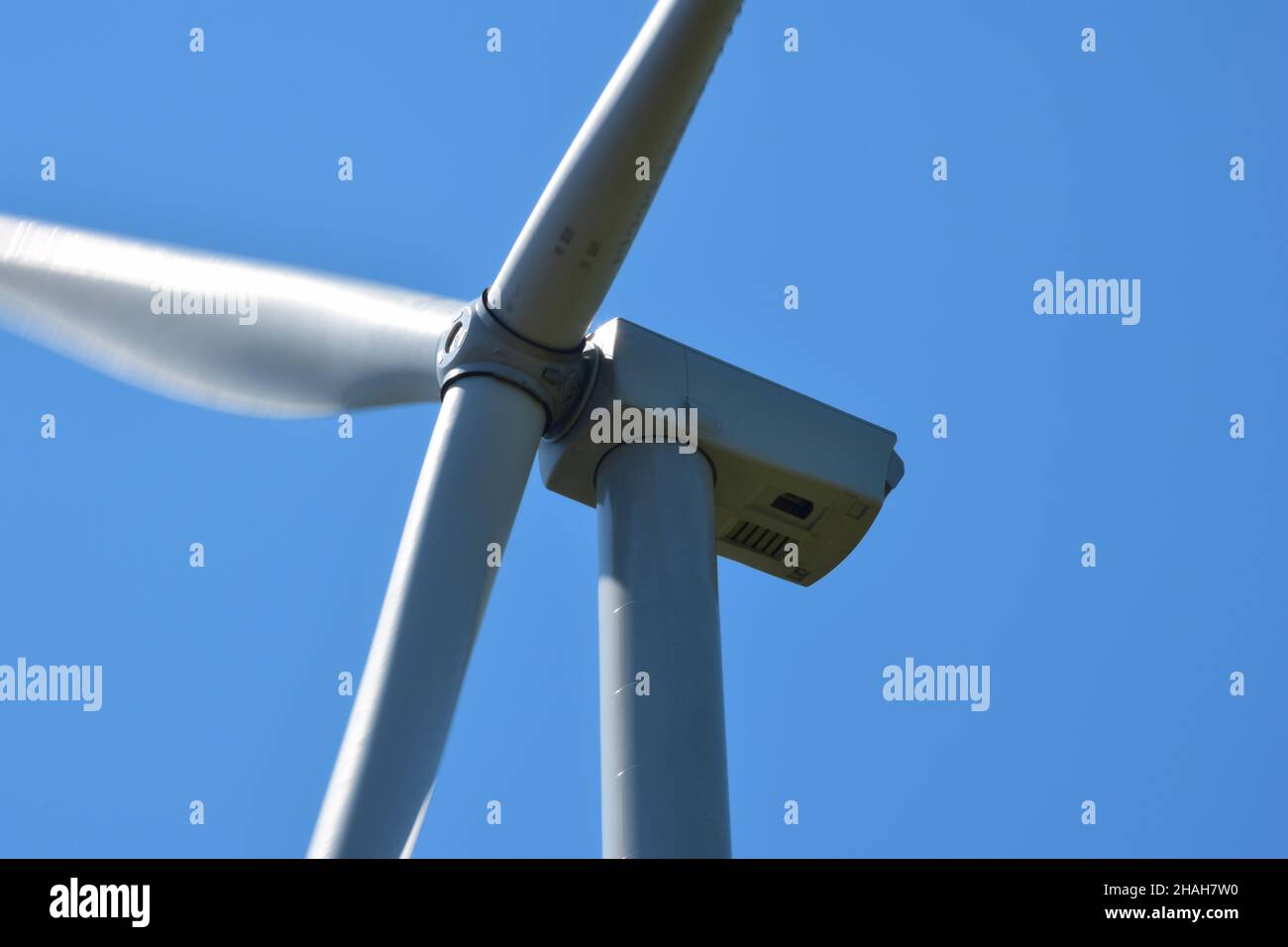 A huge wind generator close up against the backdrop of a bright clear ...