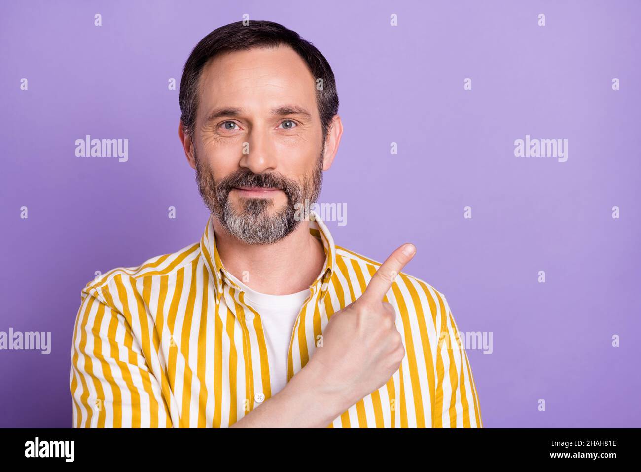 Photo of pretty cute age gentleman wear yellow shirt smiling pointing ...