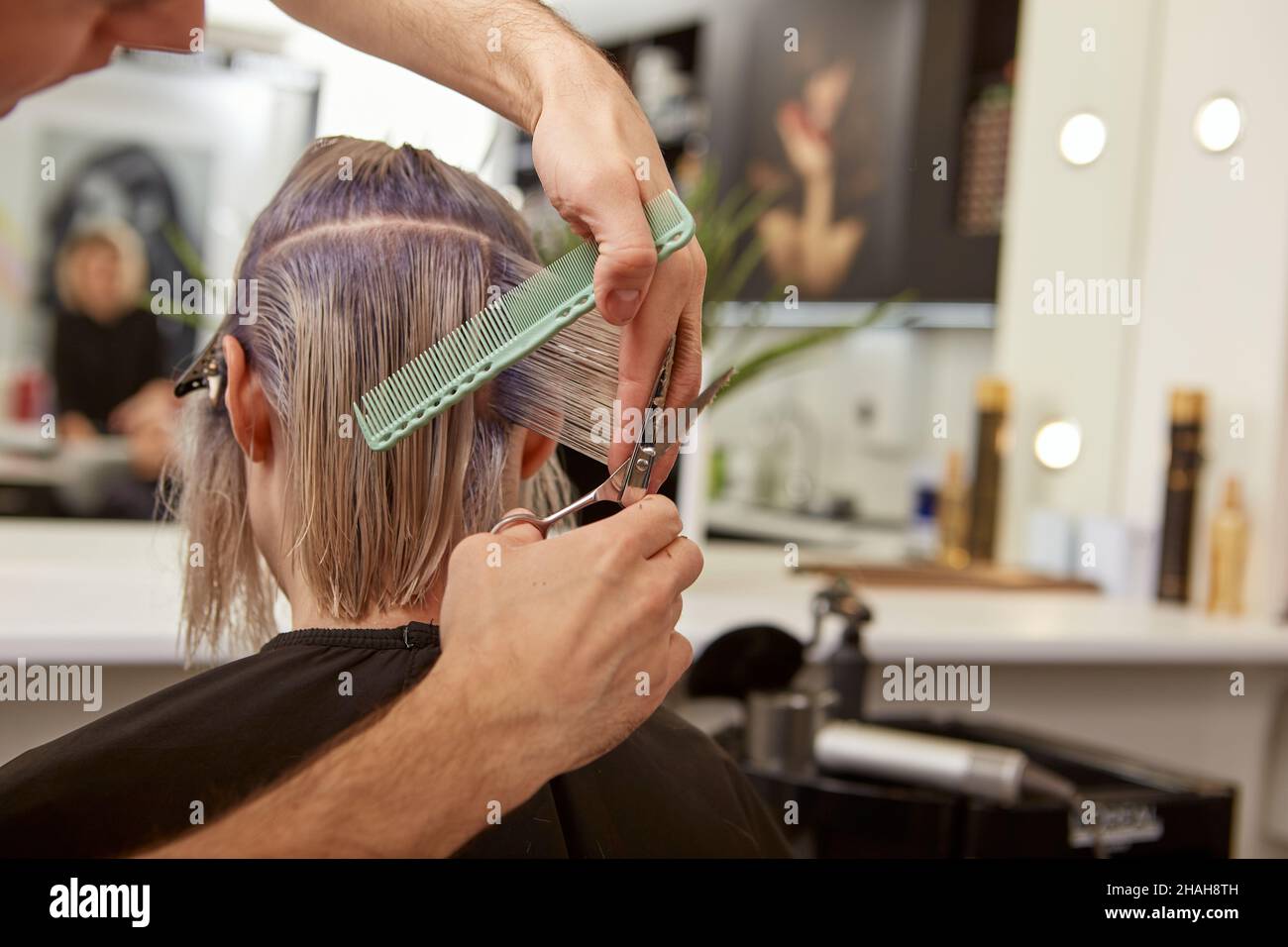 Hairdresser hands cutting woman hair with professional scissors Stock ...