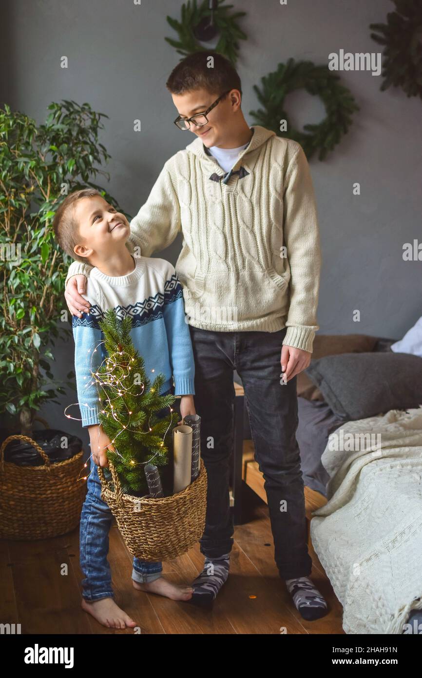 Two brothers embrace each other, look at each other and smile in the ...