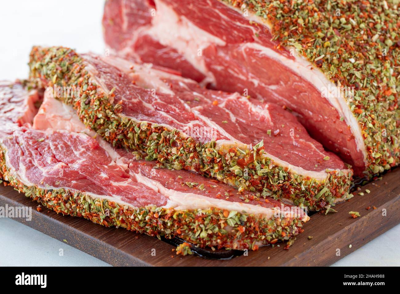 spicy fresh beef ribeye on white wooden background. Close up meat Stock ...