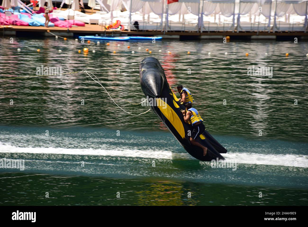 An inflatable sports raft with two men in life jackets quickly floats ...