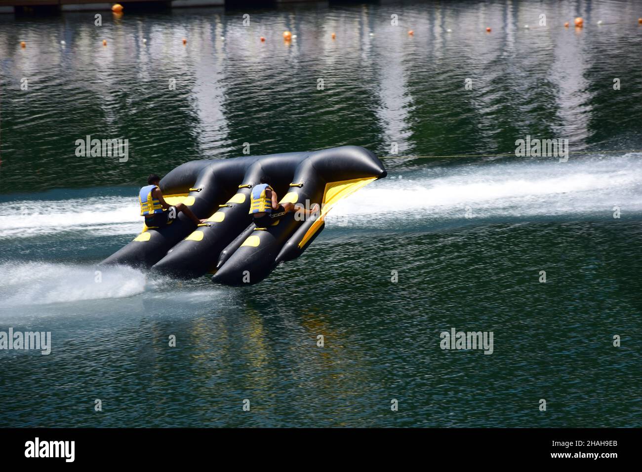 An inflatable sports raft with two men in life jackets quickly floats ...
