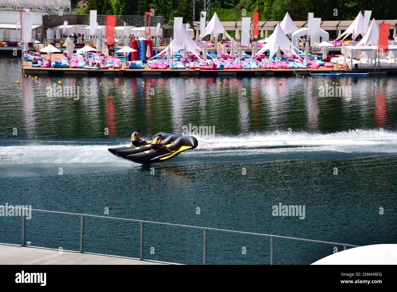 An inflatable sports raft with two men in life jackets quickly floats ...
