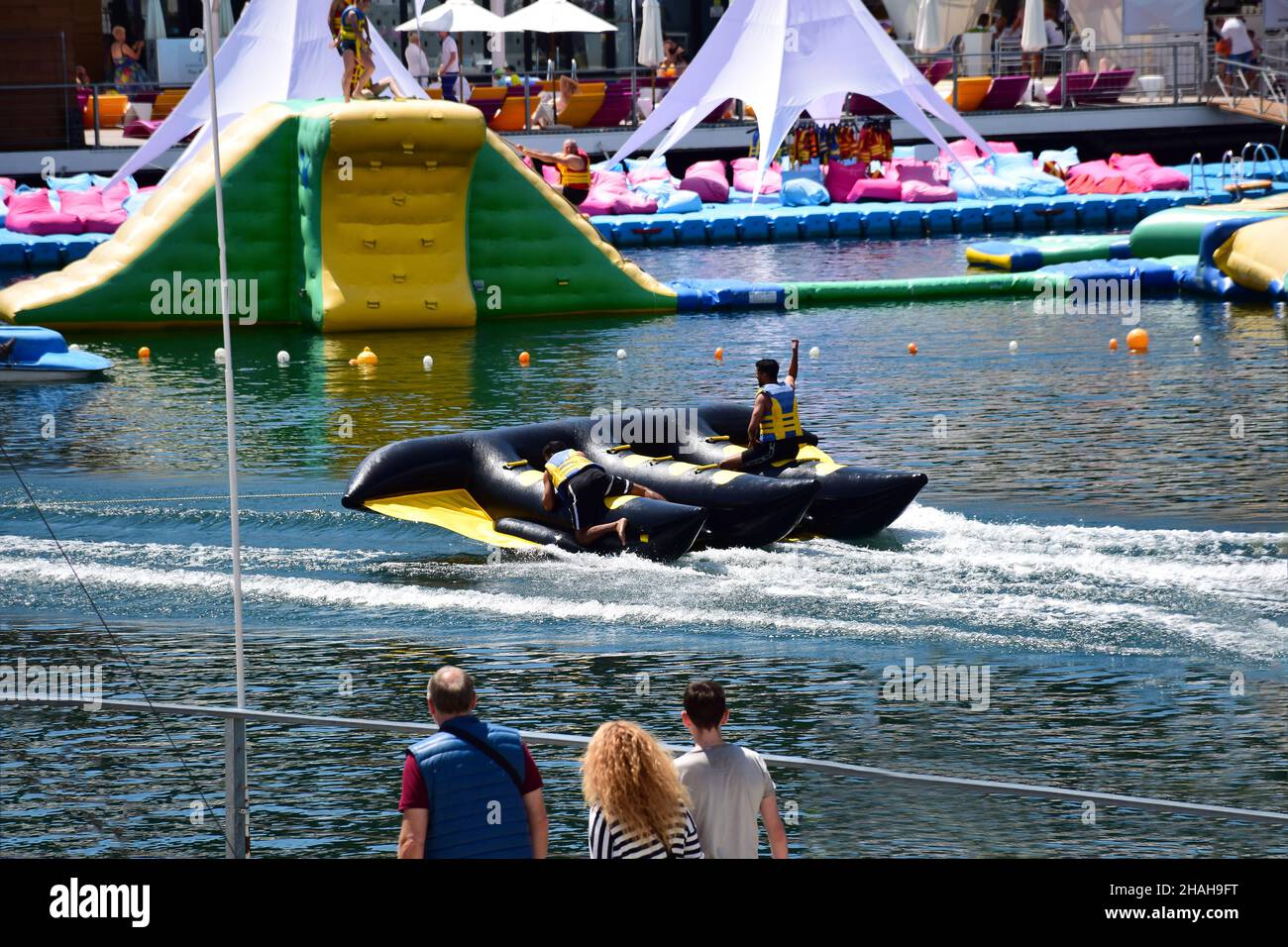 An inflatable sports raft with two men in life jackets quickly floats ...