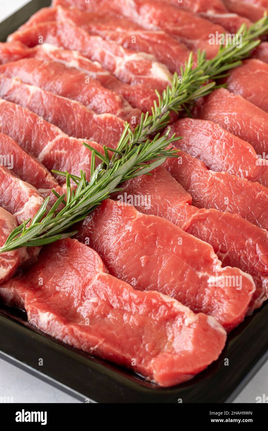 raw boneless veal steak on white wooden background. Close-up beef ...