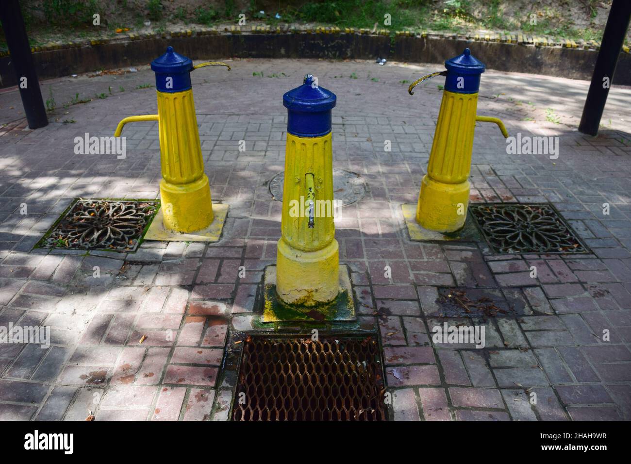 Three decorative plumbing pumps for a drinking pump room with clean ...